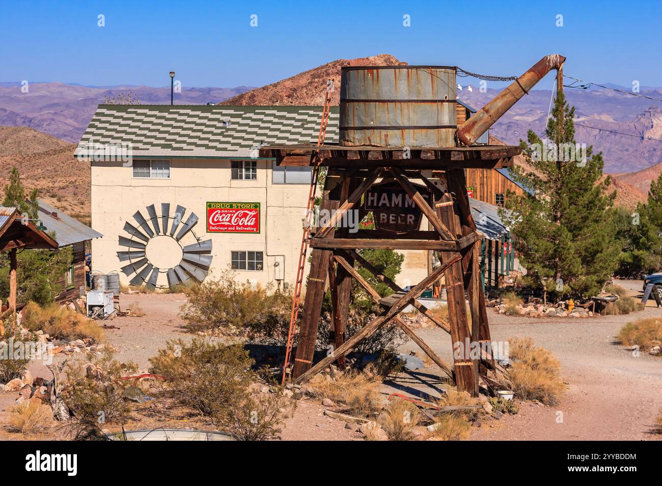 A Coca Cola sign is on the side of a building. The building is ...