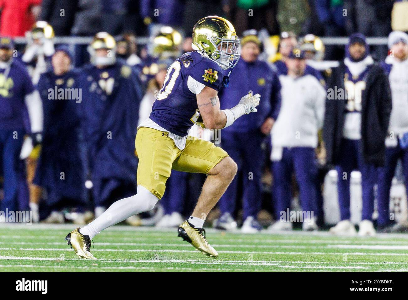 South Bend, Indiana, USA. 20th Dec, 2024. Notre Dame running back Aneyas Williams (20) runs with ...