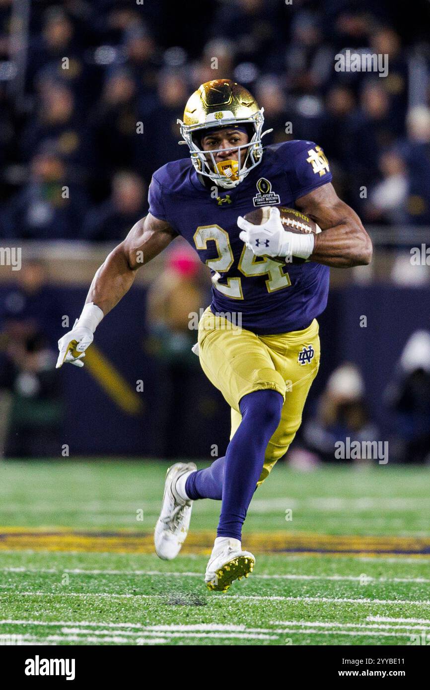 South Bend, Indiana, USA. 20th Dec, 2024. Notre Dame running back Jadarian Price (24) runs with ...