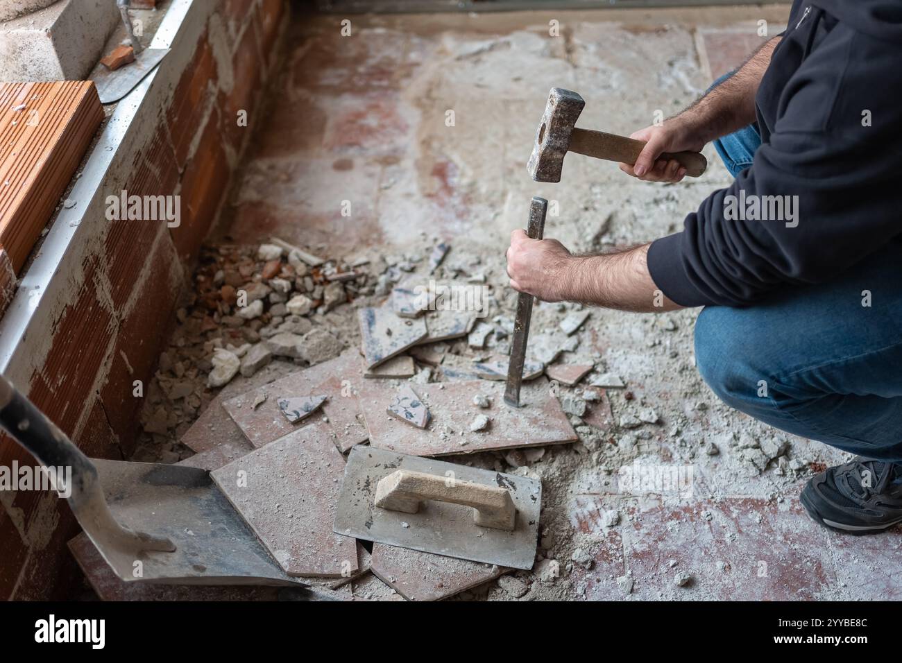 Hammer and chisel worker for manual demolition of floors and walls in ...