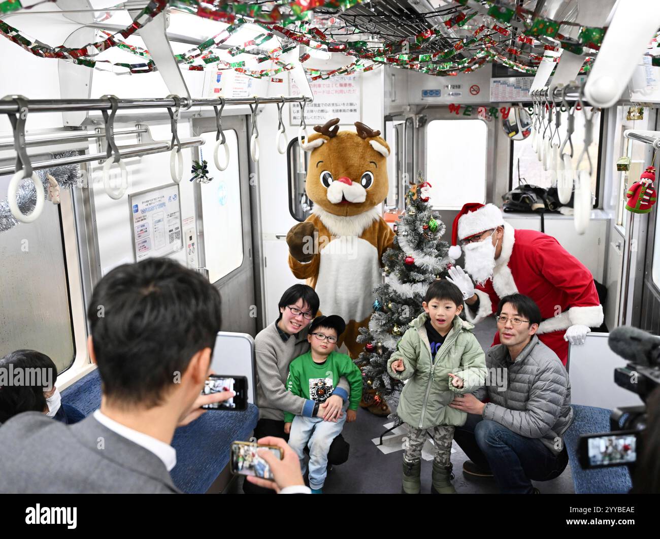 Passengers pose for photo with Santa Claus and his reindeer. "Santa ...