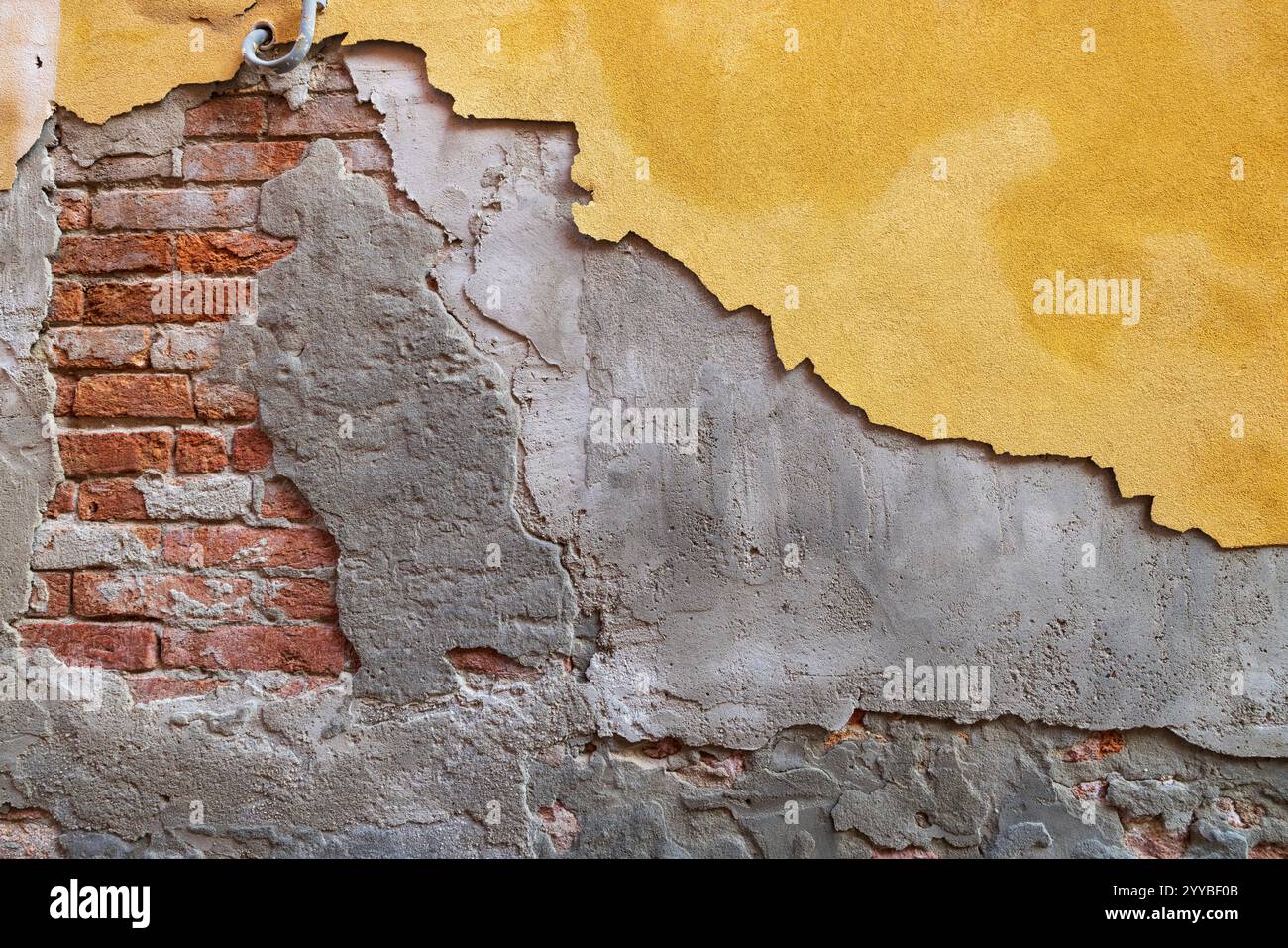 Worn wall showing layers of brick and plaster Stock Photo - Alamy