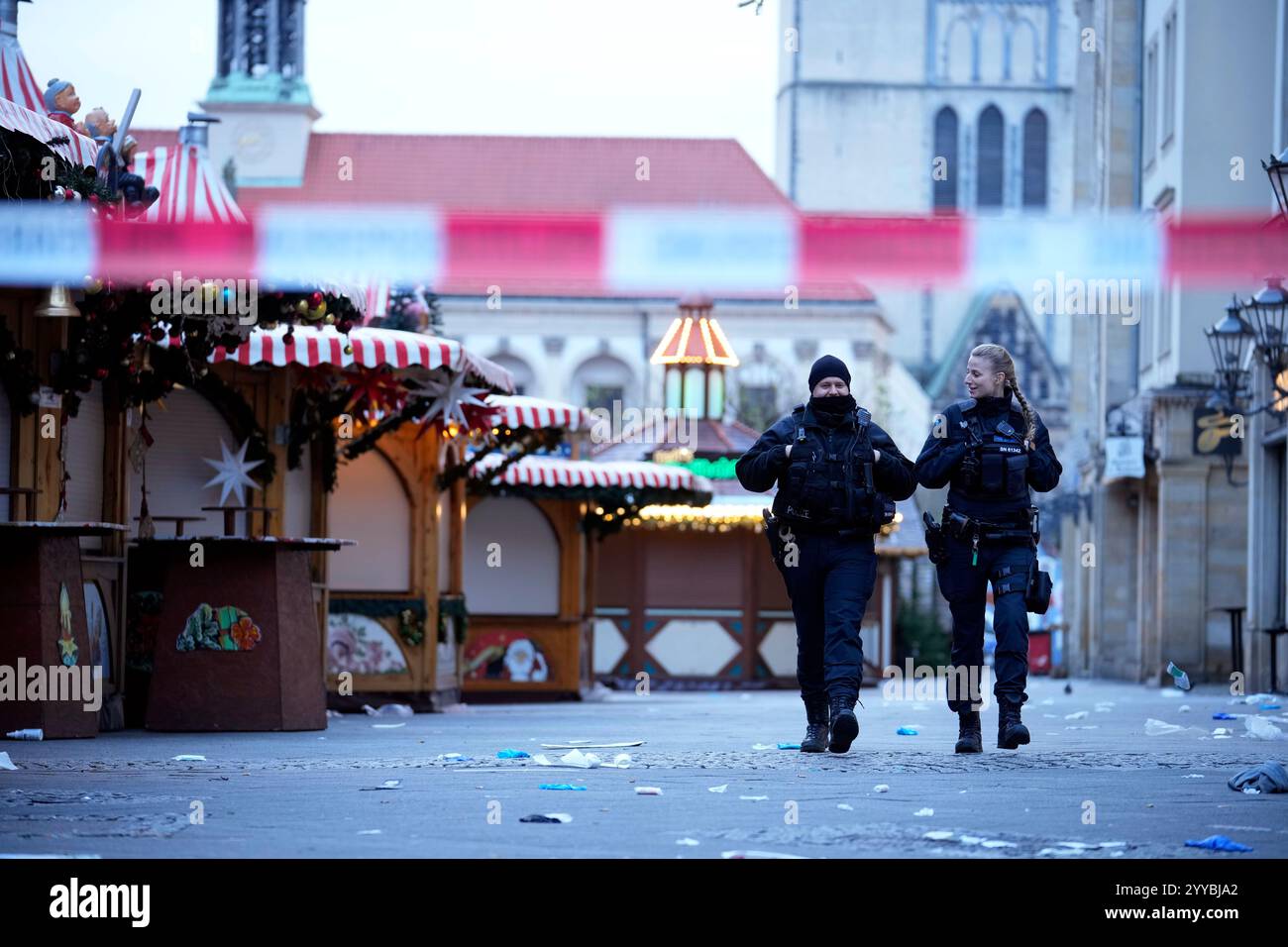 Police officers patrol a cordoned-off area at a Christmas Market, where ...