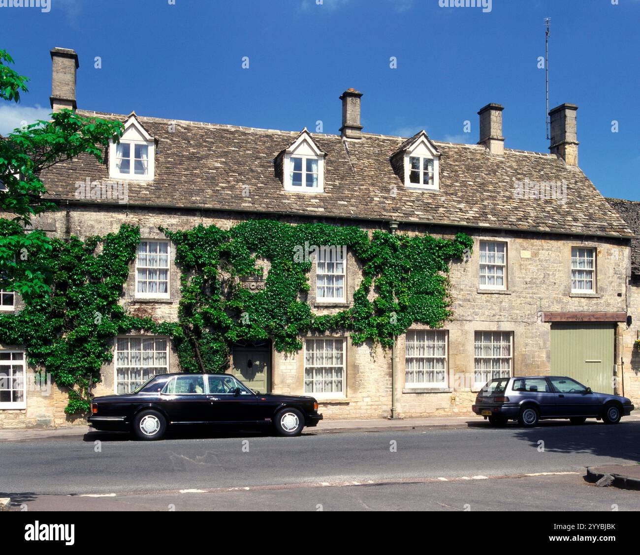 June 1996: Roadside Cotswold stone town houses, Street scene ...