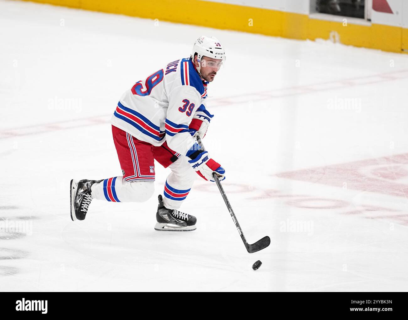 New York Rangers center Sam Carrick controls the puck during an NHL ...