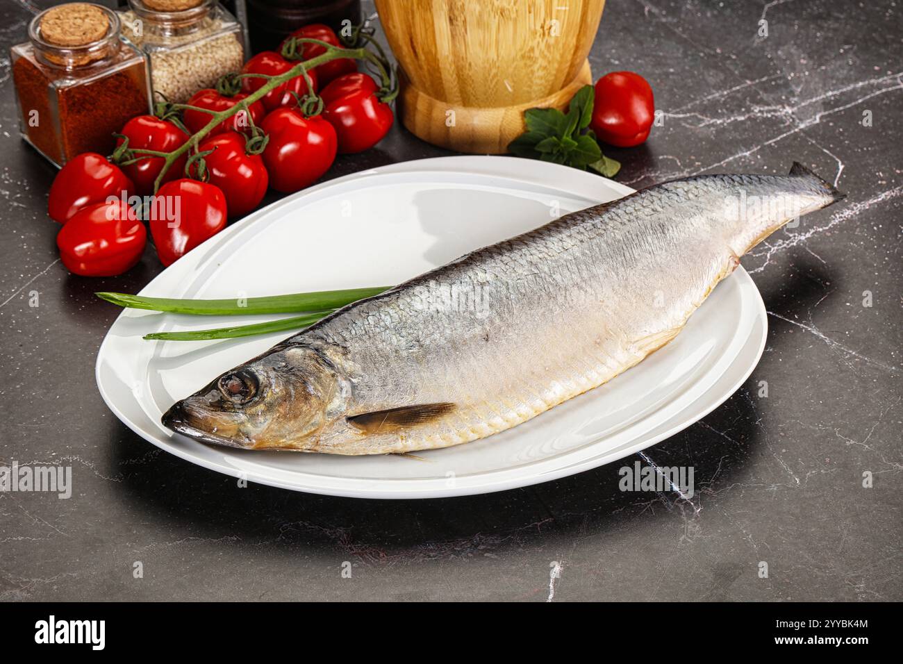 Whole raw salted herring fish in the plate Stock Photo - Alamy