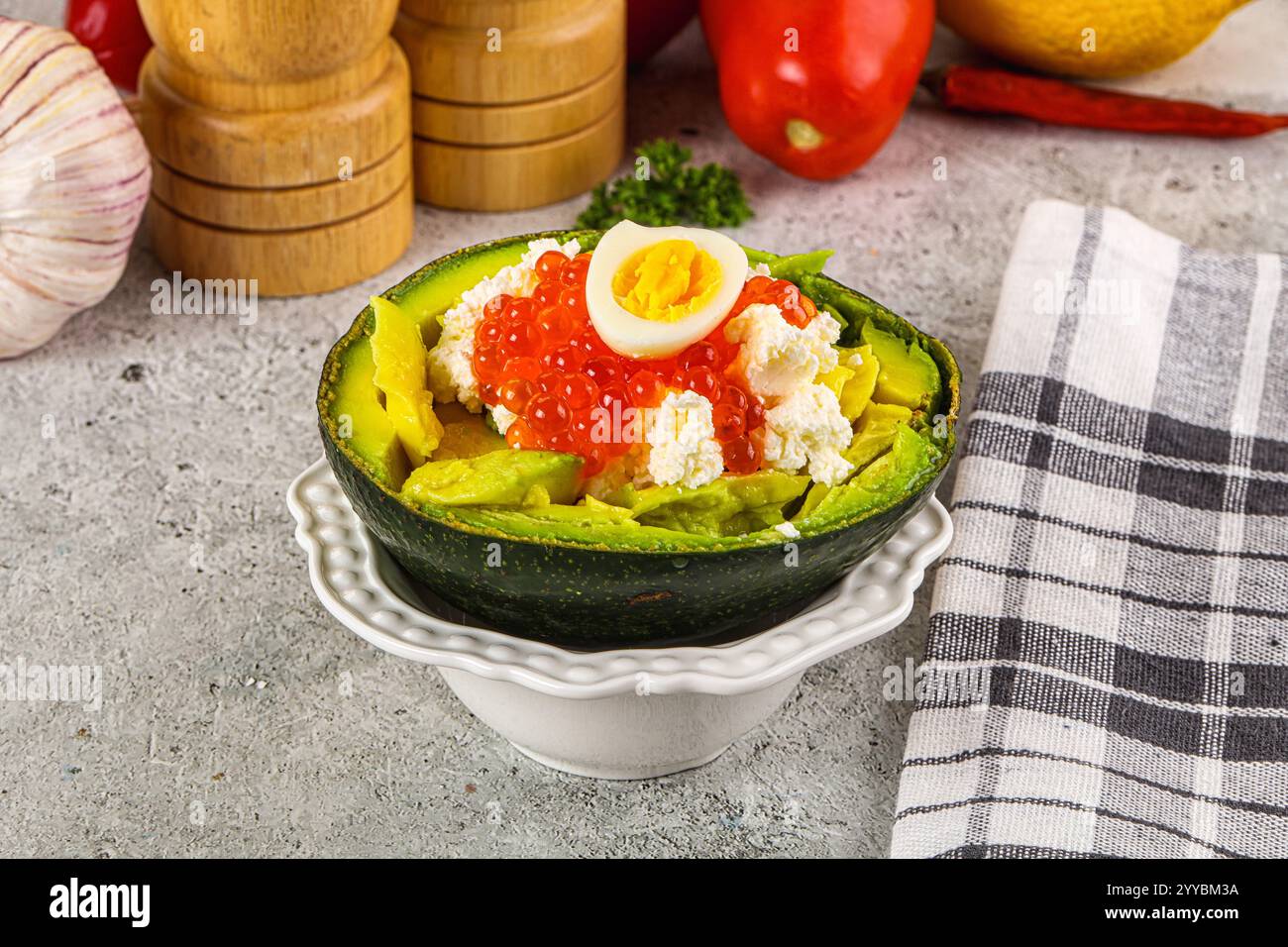Avocado with red caviar and quil egg and soft cheese Stock Photo - Alamy