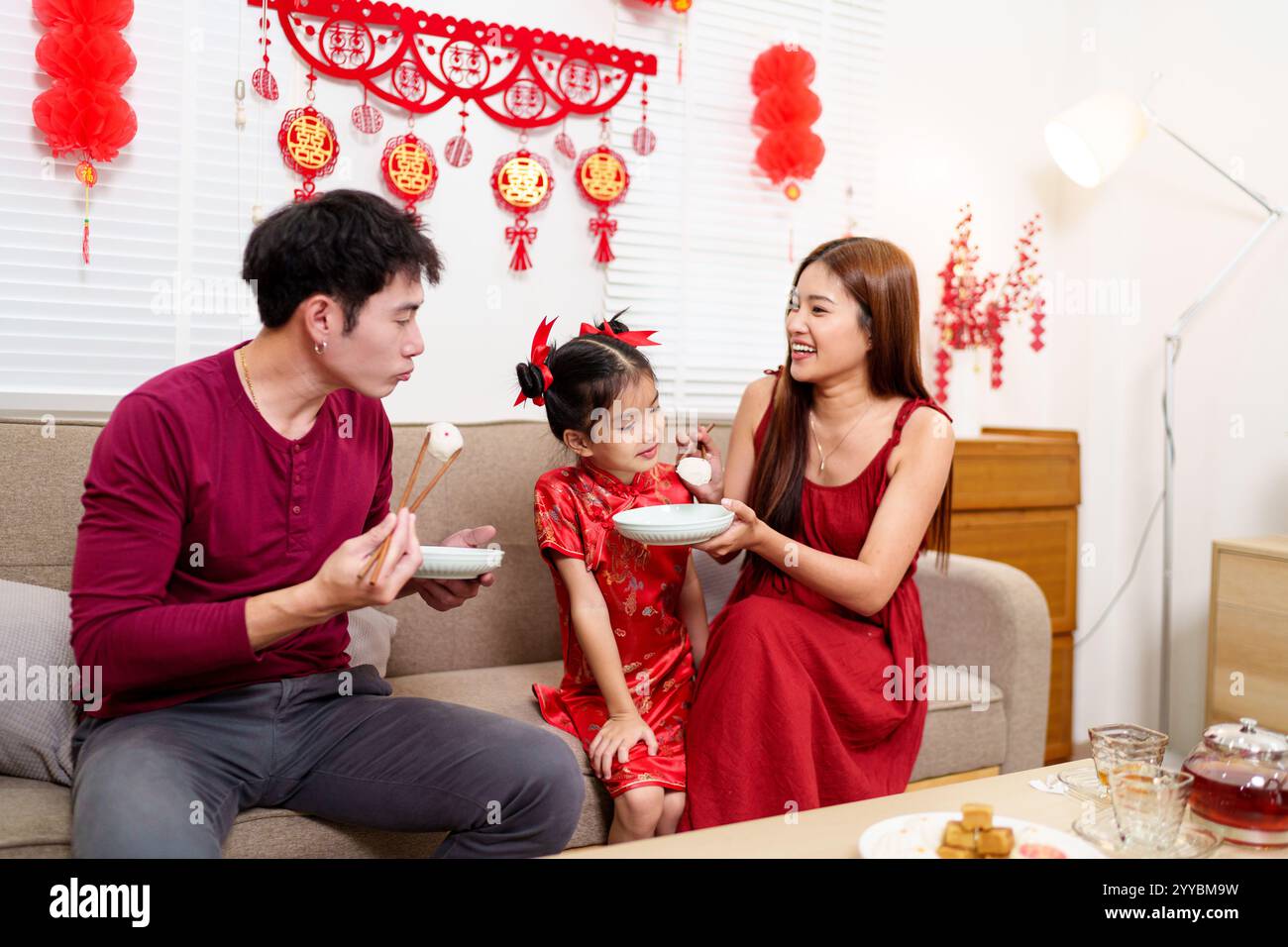 An Asian family of Chinese descent enjoys a festive meal together ...