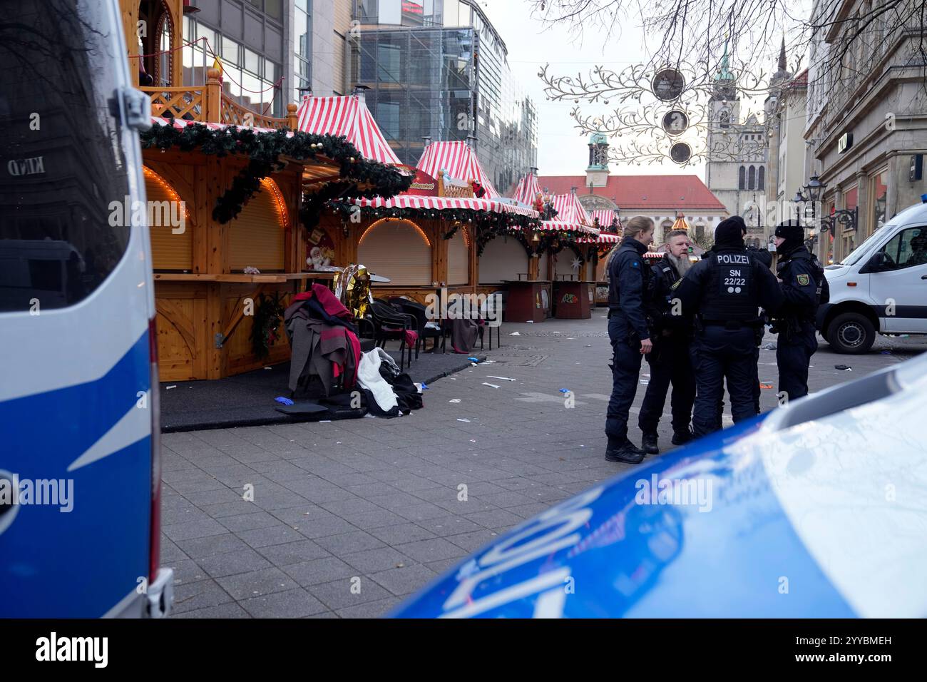 Police officers stand at a cordoned-off Christmas Market, where a car ...