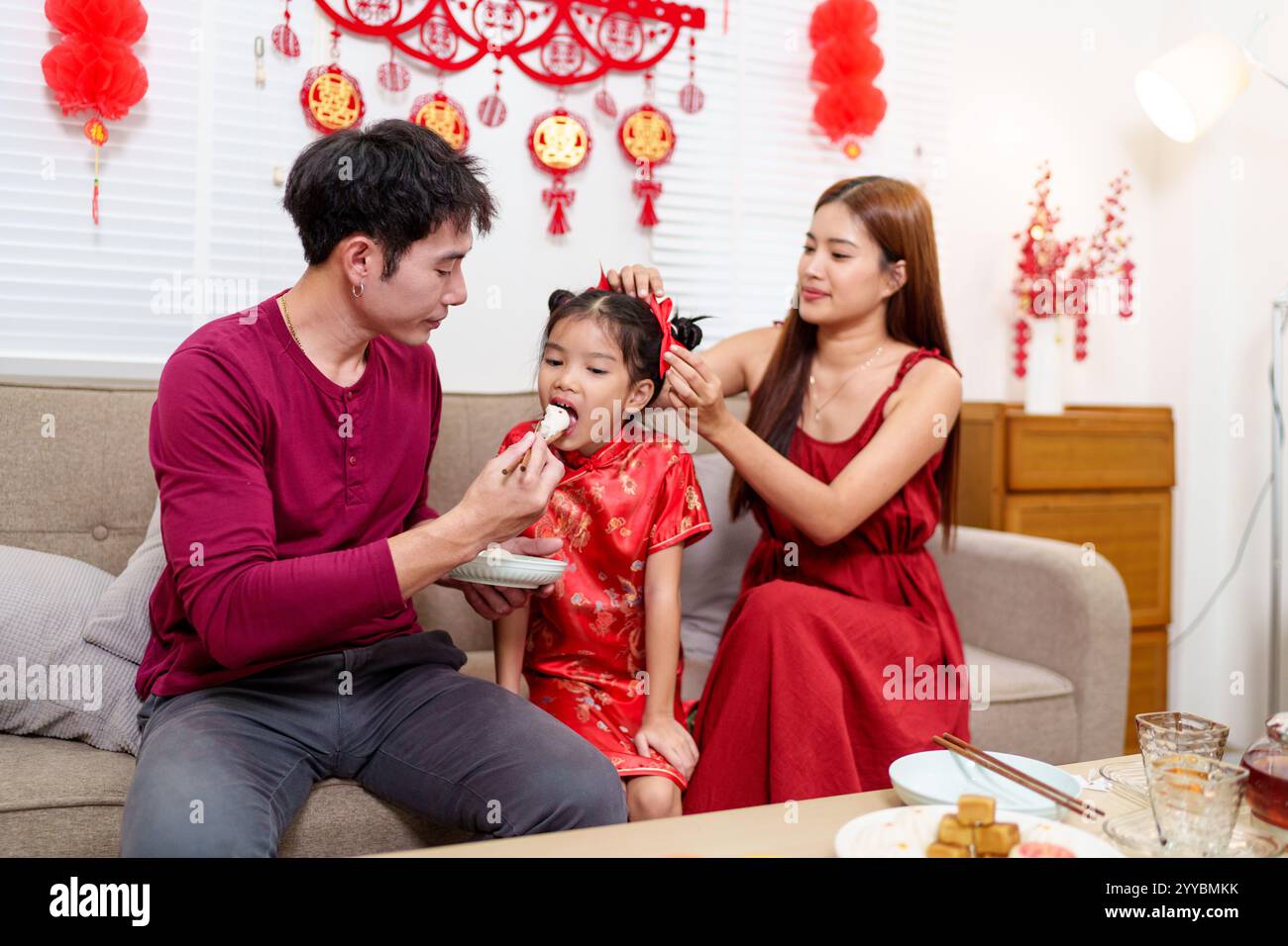 An Asian family of Chinese descent enjoys a festive meal together ...