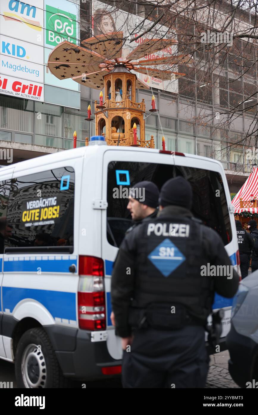 Magdeburg, Germany. 21st Dec, 2024. Police officers stand at the ...