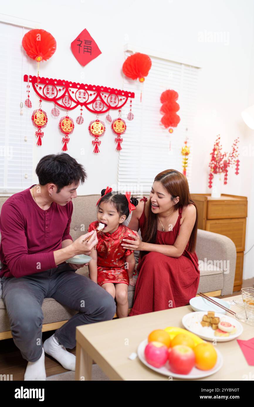 A loving Chinese family shares a joyful moment while dining together ...