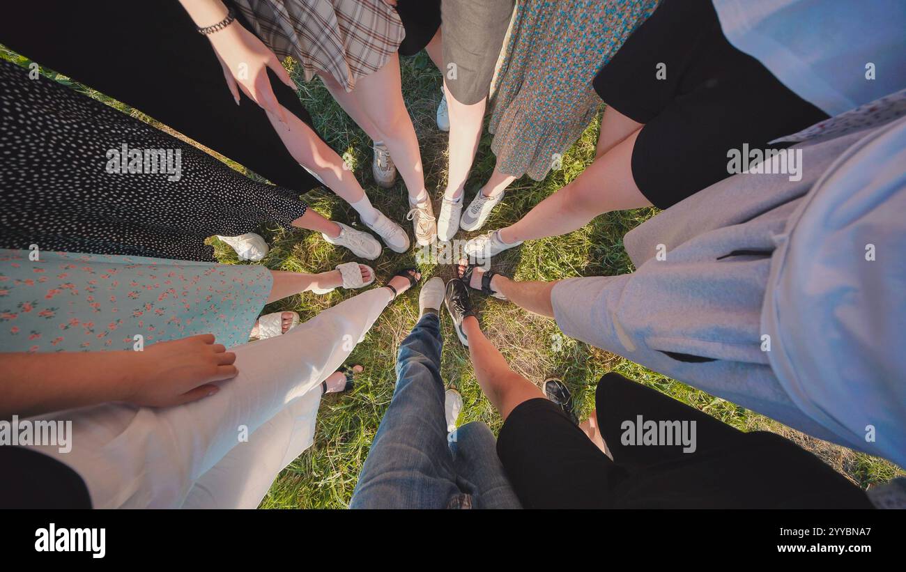 High school students gather in a circle outdoors during the summer ...