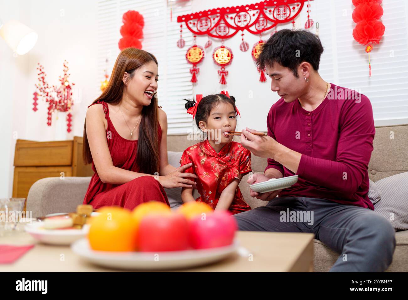 A loving Chinese family shares a joyful moment while dining together ...