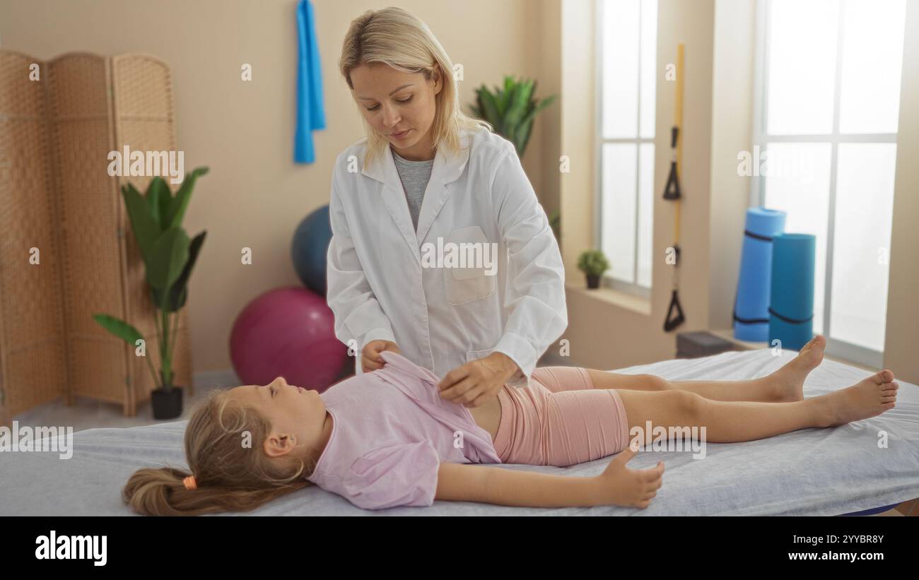 Woman therapist assessing child patient on a treatment table in a ...