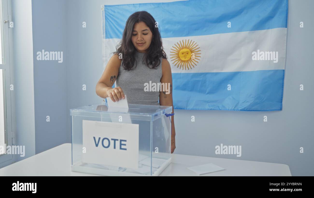 A young woman is voting in an indoor electoral room with an argentinian ...
