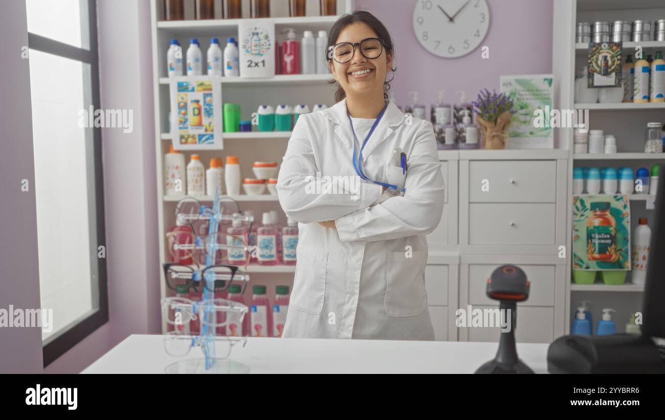Smiling female pharmacist standing confidently with folded arms in a ...