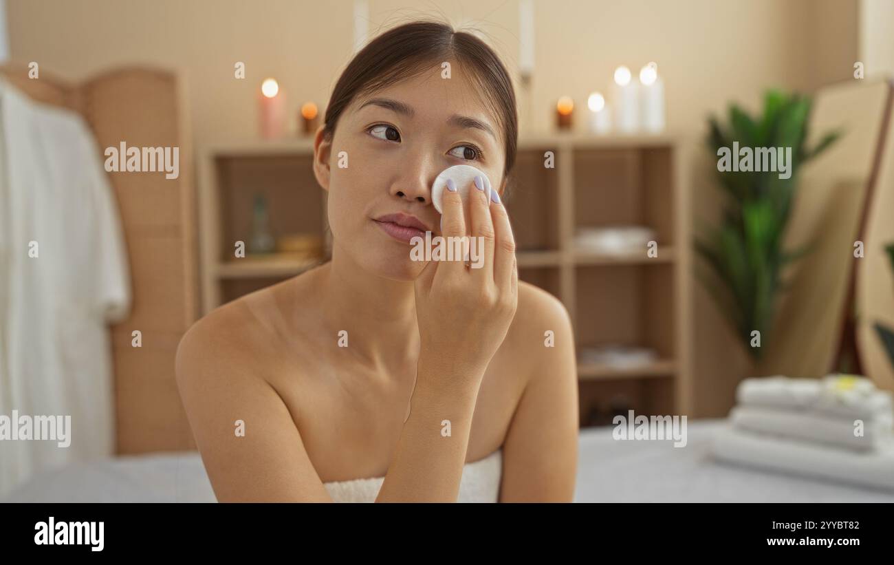 Woman applying facial product in a spa room, showcasing a serene beauty ...