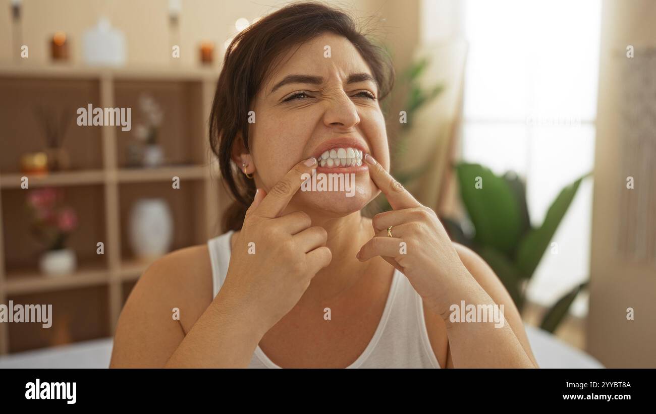 Woman pointing at her teeth in a wellness center with a serene indoor ...