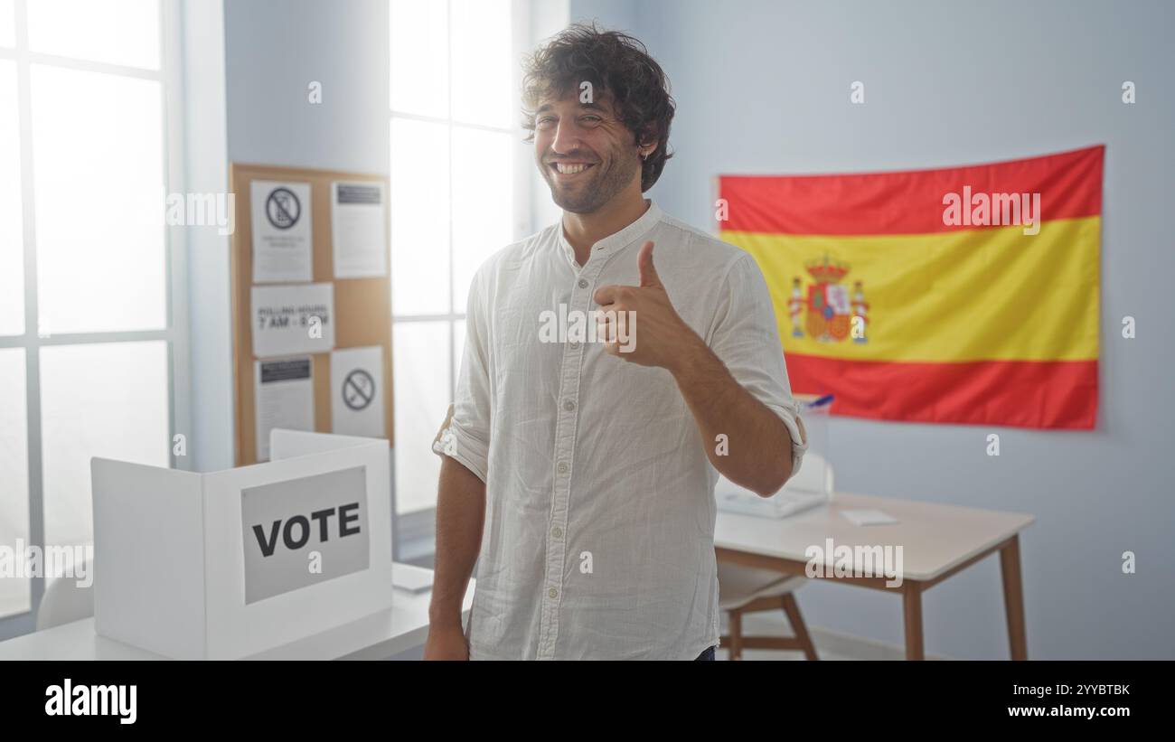 Young man smiling in an electoral room giving a thumbs up with a ...