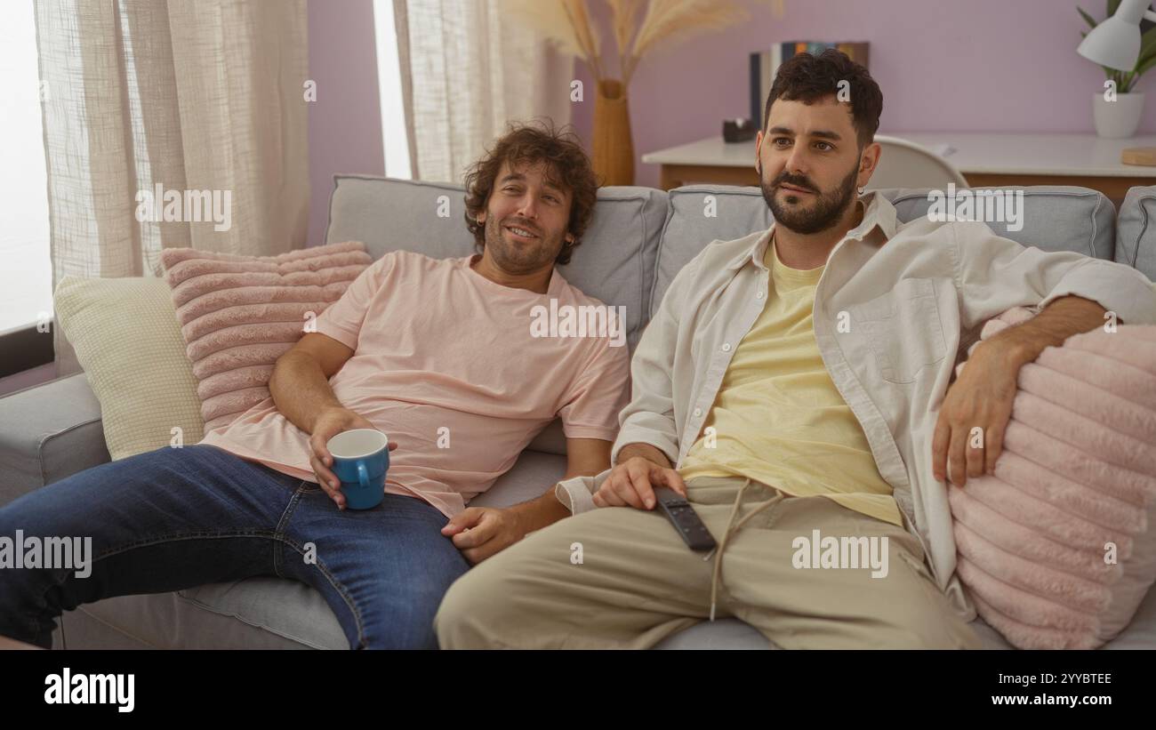 Two men sitting together on a cozy couch in a modern living room ...