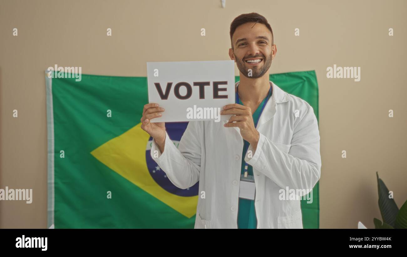 A handsome young hispanic man with a beard stands in an indoor ...
