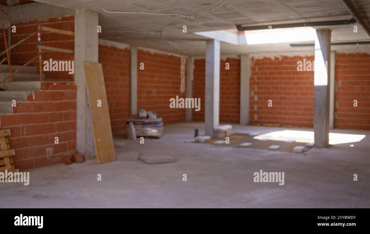Blurred view of an unfinished construction site with brick walls and ...