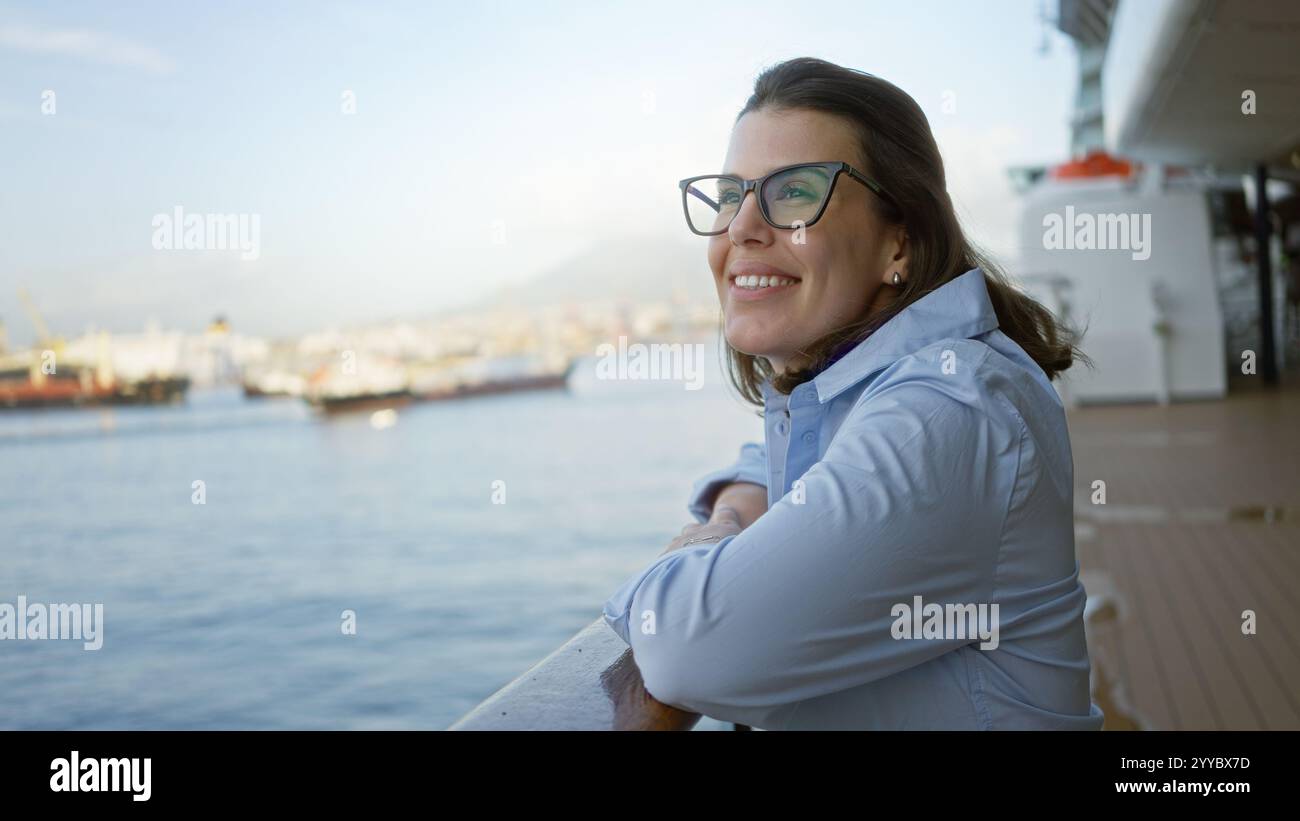 Hispanic woman smiling on a cruise ship's outdoor deck with a scenic ...