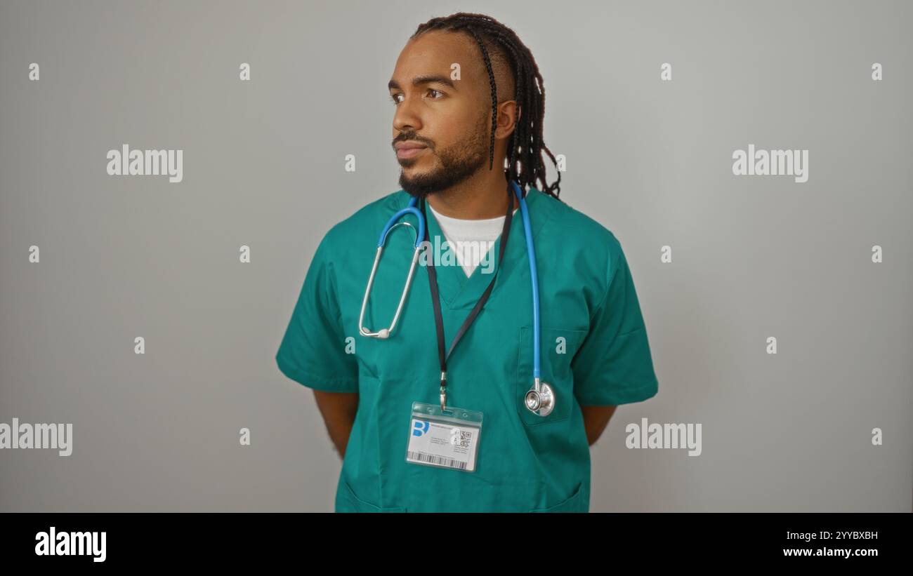 Young man with braids wearing scrubs and stethoscope looks confidently ...