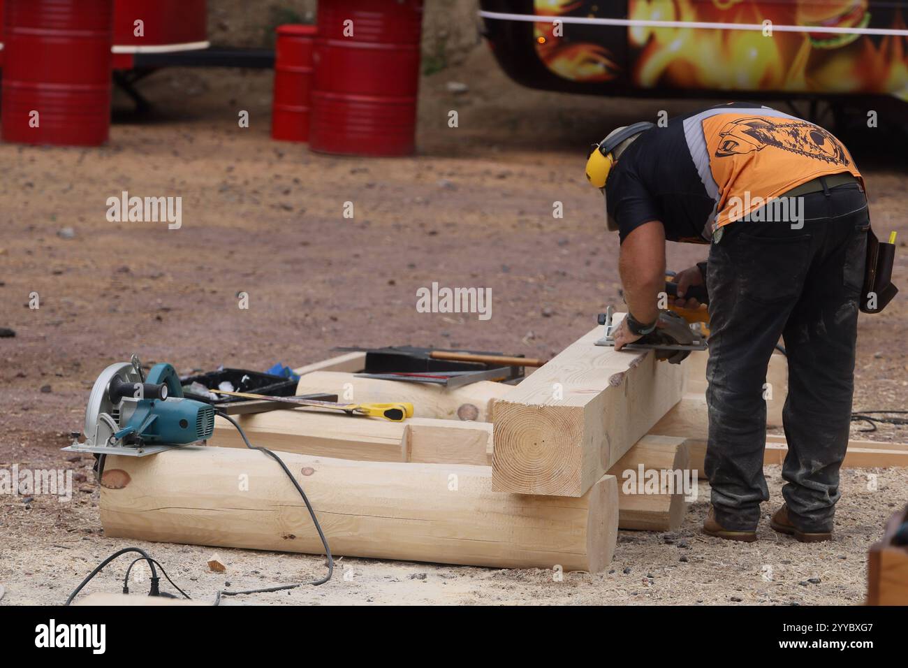 A carpenter at a construction site displays skills and craftsmanship ...