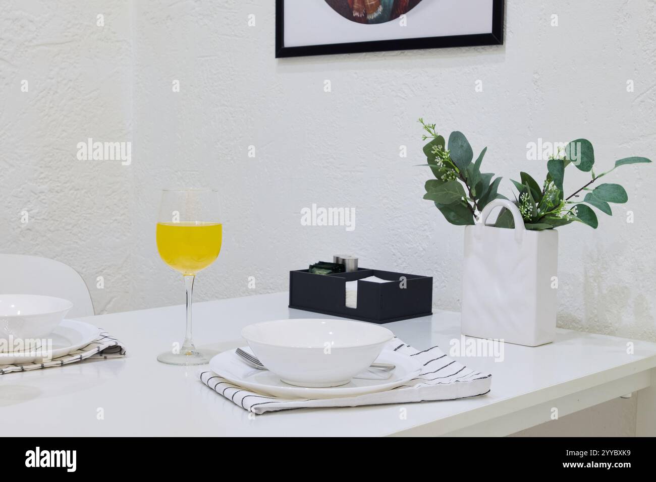 A Chic and Stylish Dining Table Setup Featuring Glass Elements, Decor ...