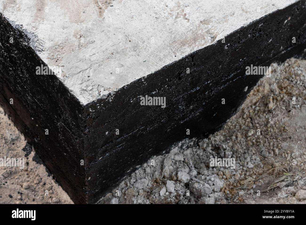A corner of foundation made of reinforced concrete is covered with a ...