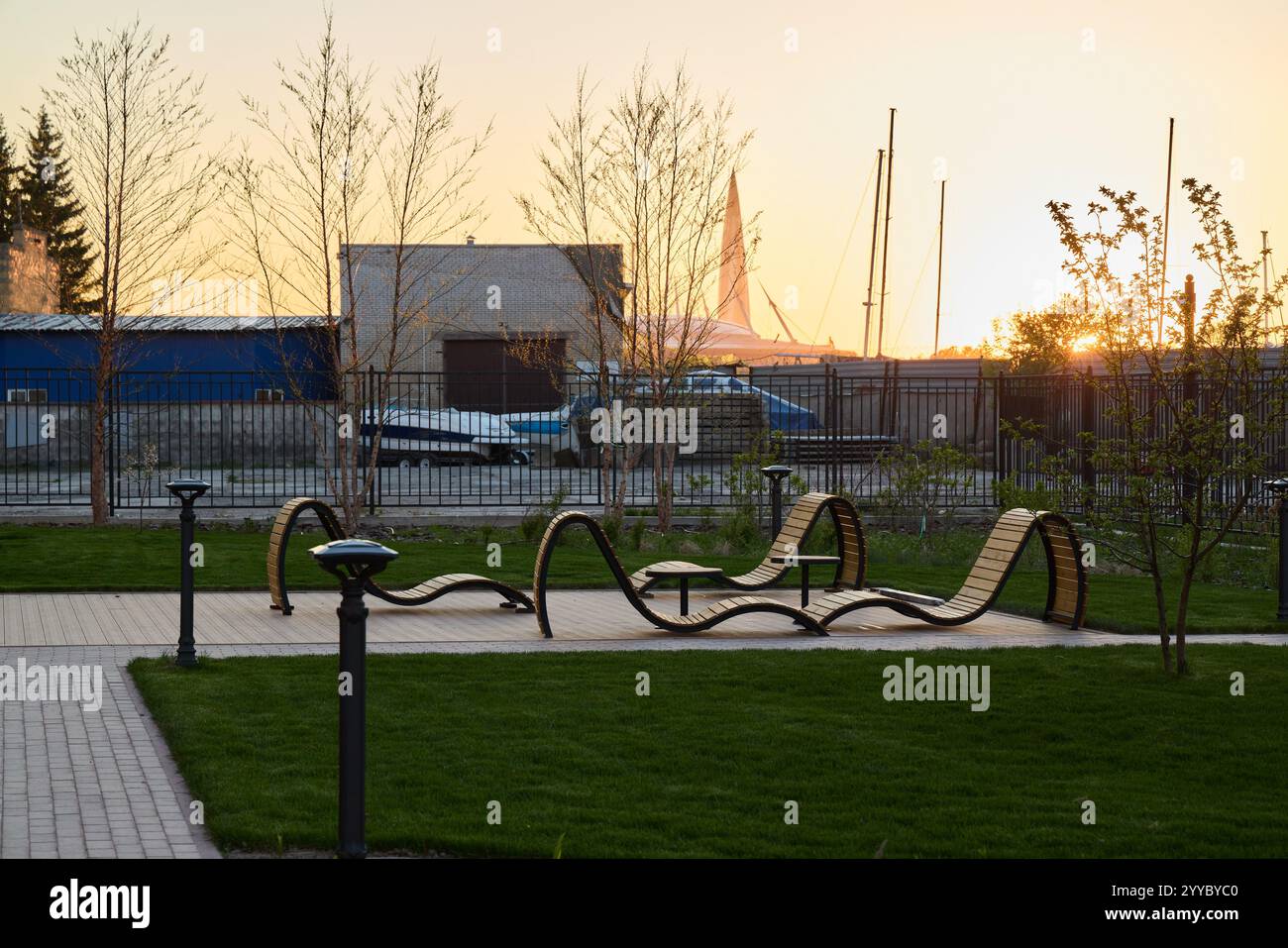 A tranquil and serene sunset view showcasing modern seating options in ...
