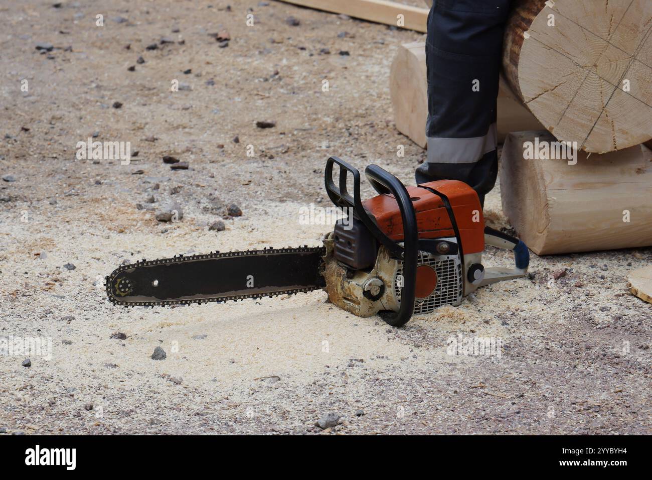 This image shows a closeup of a chainsaw cutting wood, highlighting the ...