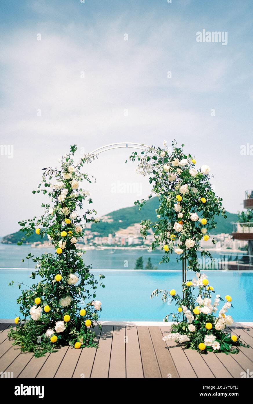 Colorful wedding arch stands on the shore of the pool Stock Photo - Alamy
