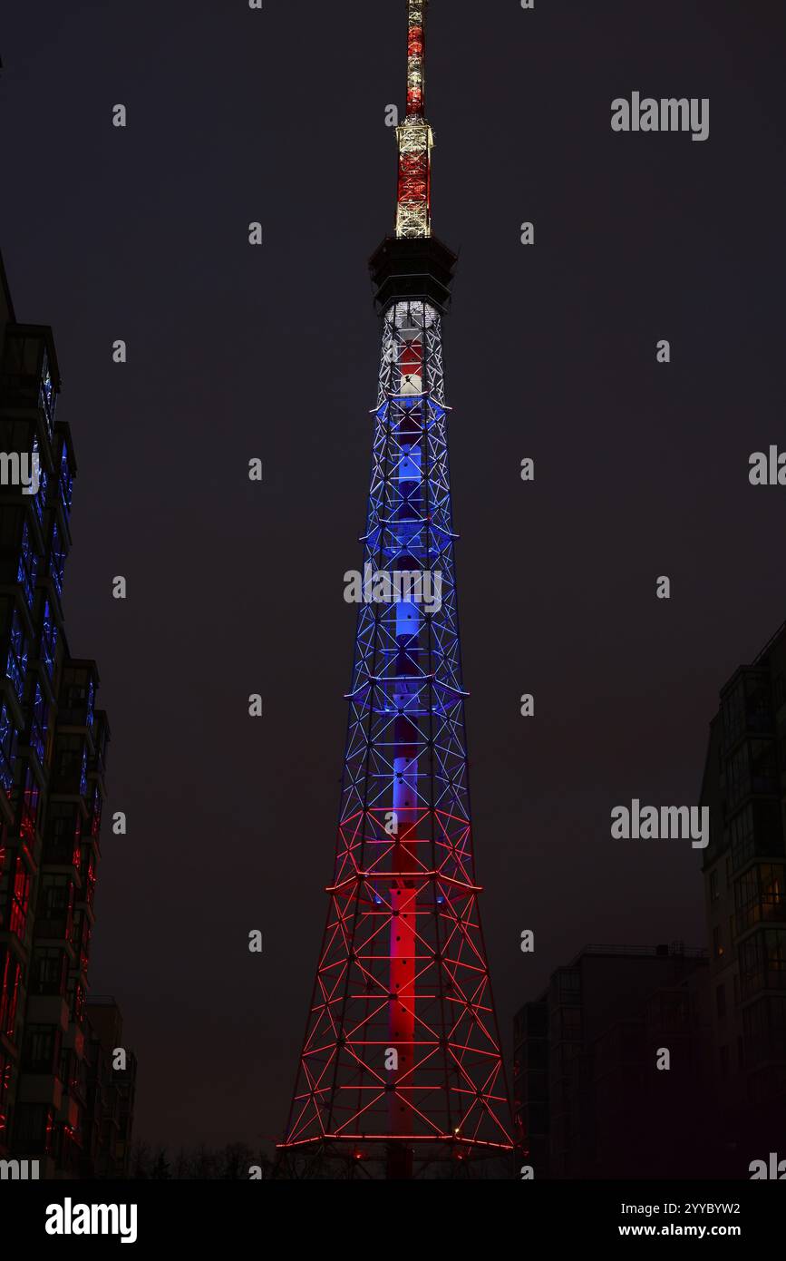 The Tokyo Tower is beautifully illuminated in vibrant red, white, and ...
