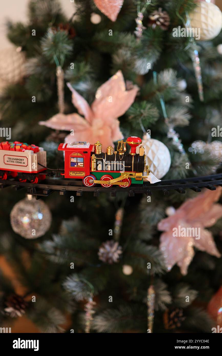 A beautiful and festive Christmas Train Ornament adorning the branches ...