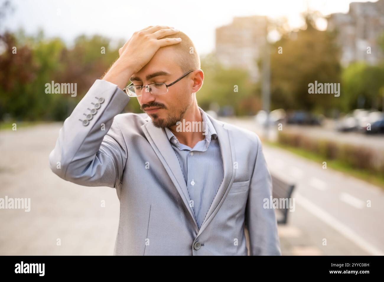 Portrait of anxious and displeased young businessman who is standing in ...