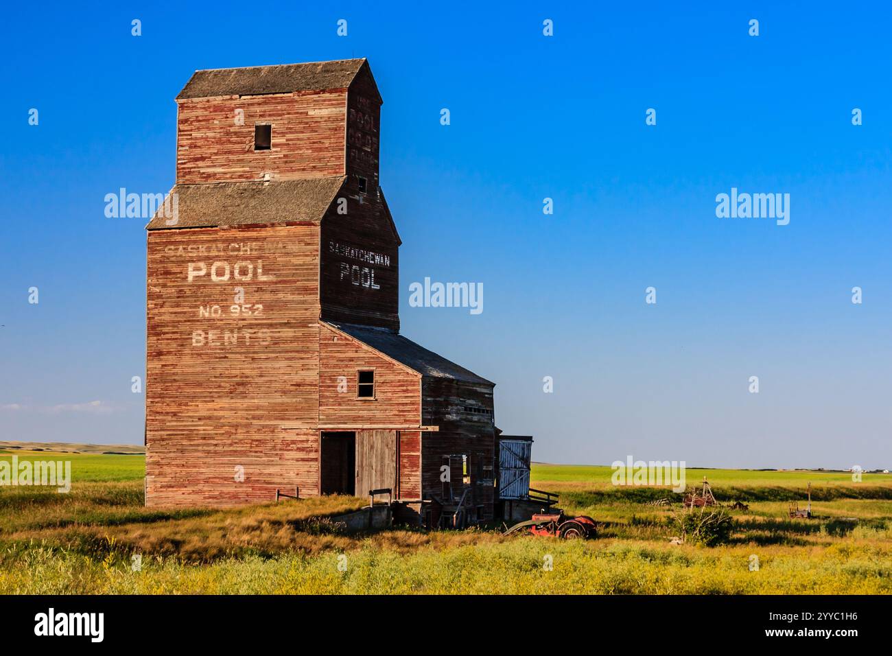 A large red grain silo with the words POOL on it. The silo is ...