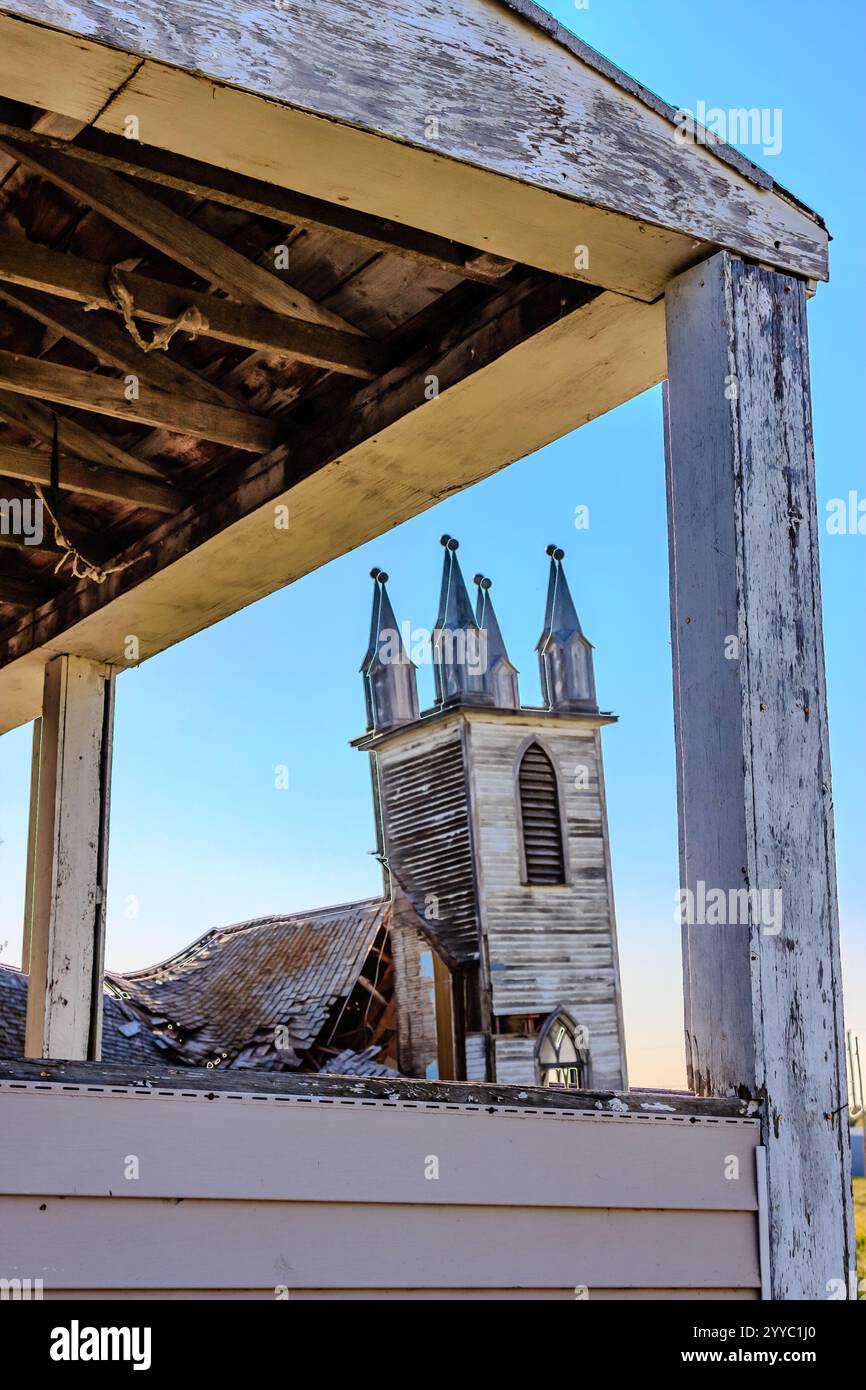 A church steeple with four spires is visible from a porch. The building ...