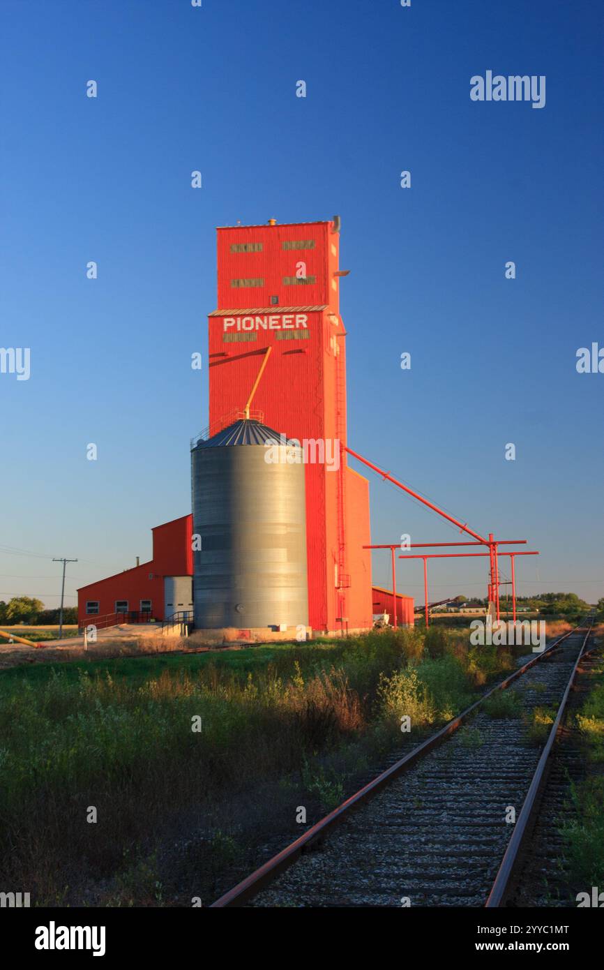 A large red grain silo with the word Pioneer written on it. The silo is ...