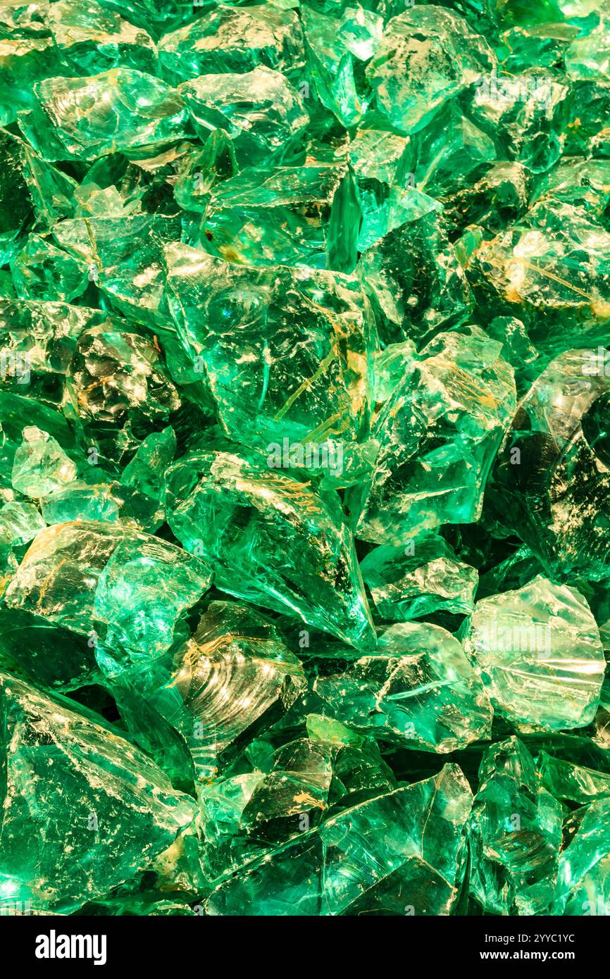 A pile of green glass shards. The shards are all different sizes and ...