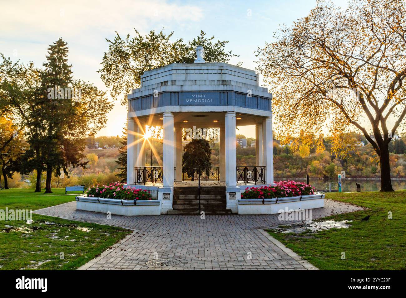 A small pavilion with a sun shining on it. The pavilion is surrounded ...