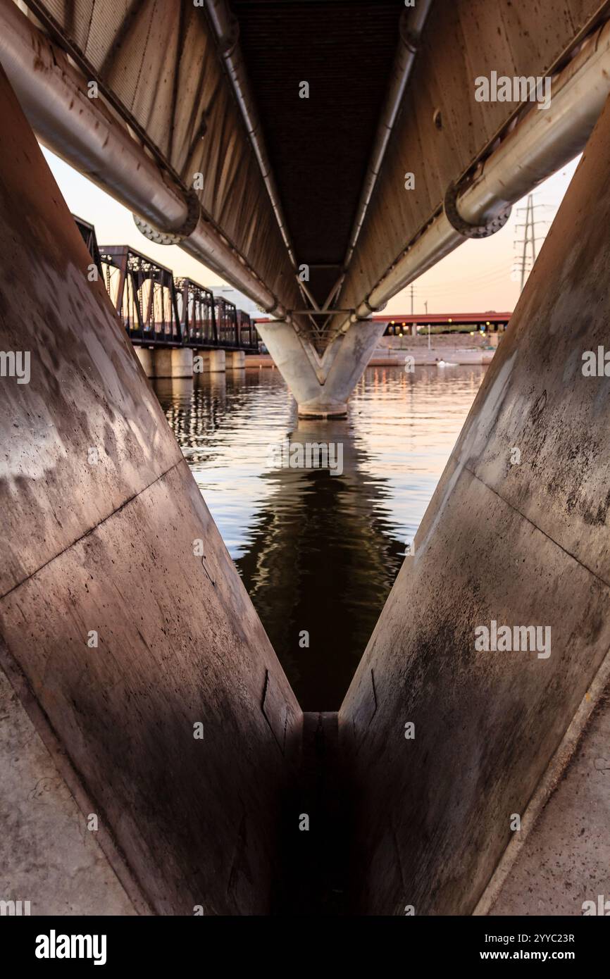 A bridge with a view of the water below. The bridge is made of concrete ...