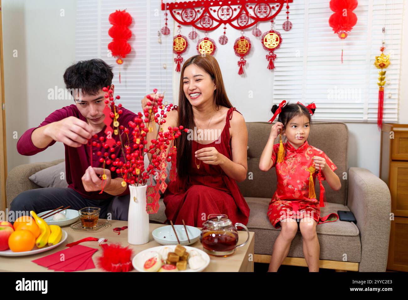 A Chinese family collaborates to decorate their home with festive ...