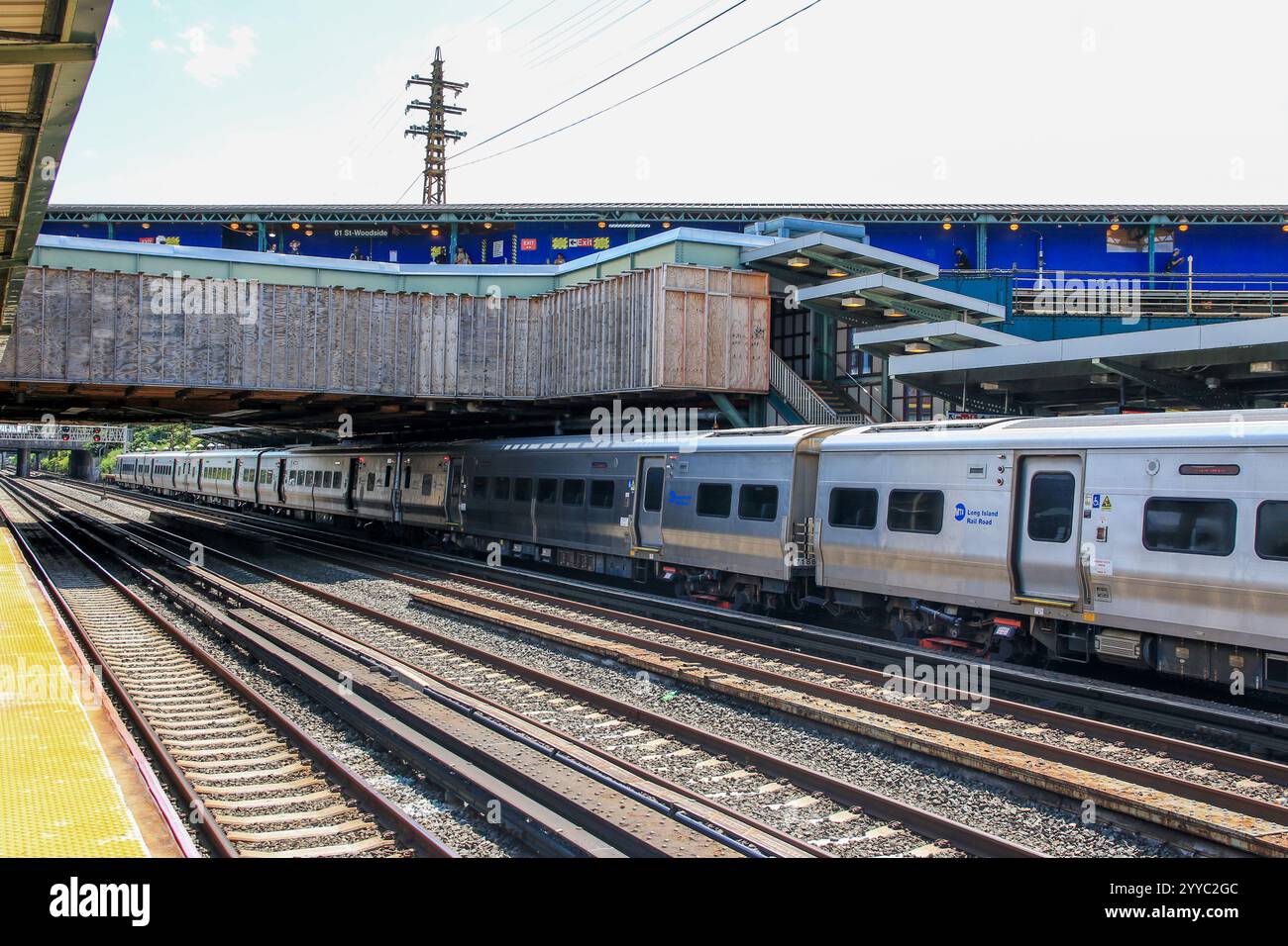 Woodside, Queens, USA - 20 August 2024: A commuter train approaches the ...
