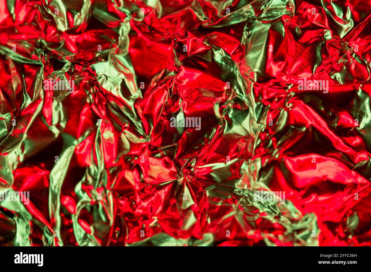 Abstract of sheet of crumpled aluminum foil with red and green light ...