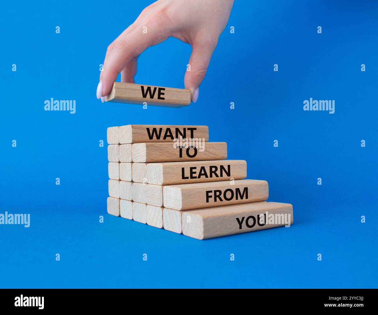 We want to learn from you symbol. Wooden blocks with words We want to ...