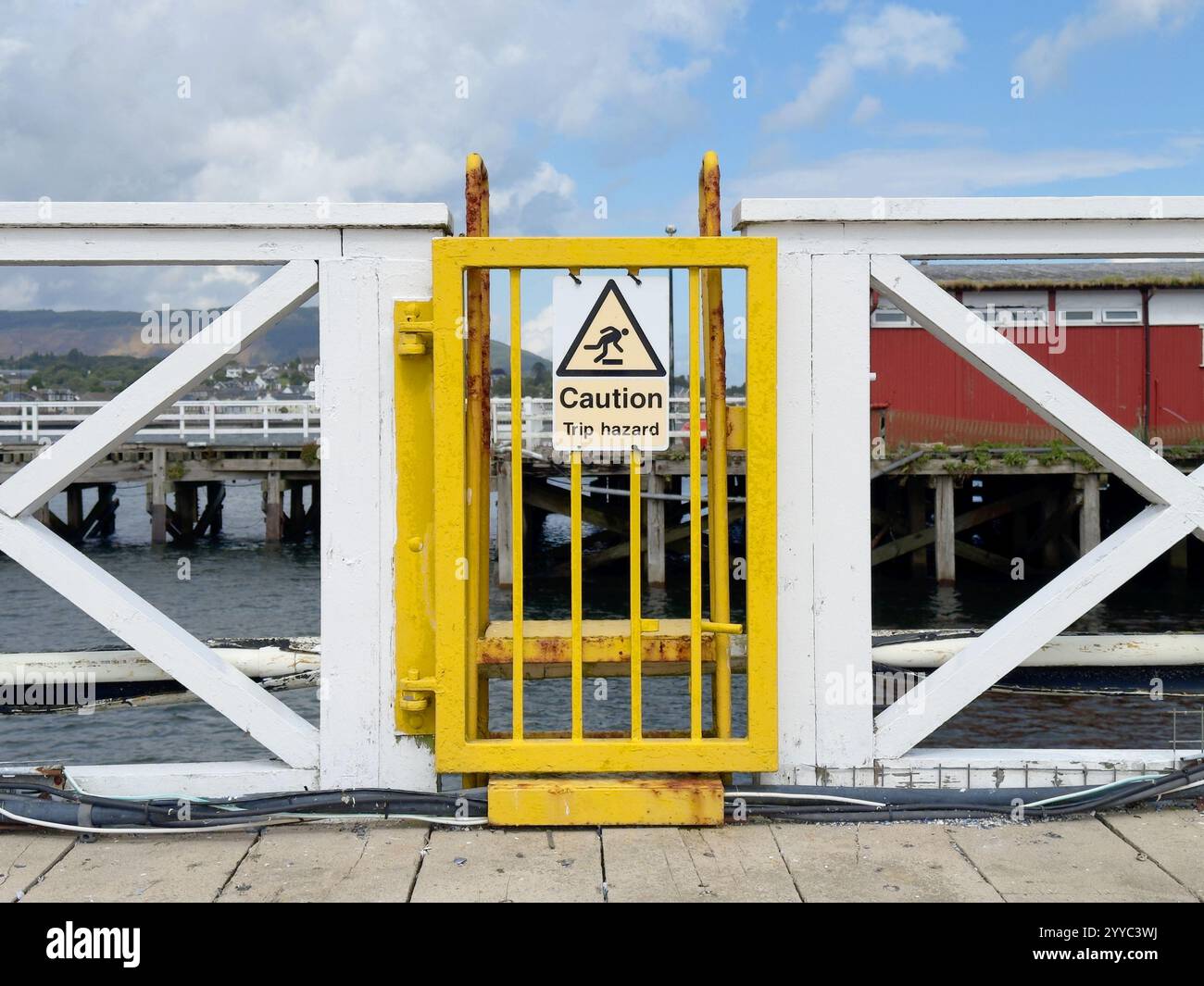 Trip hazard sign at top of stair down to water from harbour pier Stock ...