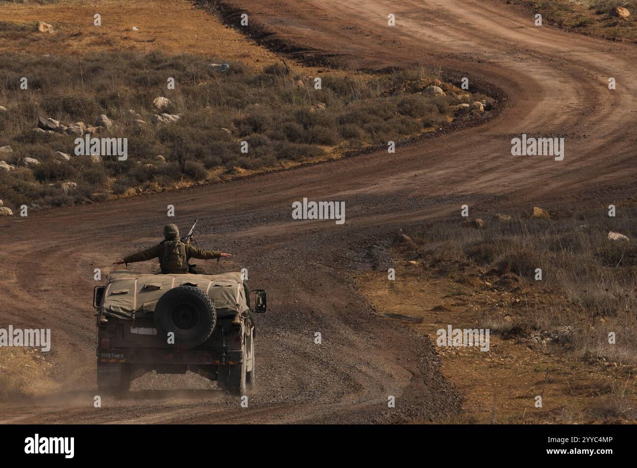 An Israeli soldier stands on an armoured vehicle on the buffer zone ...